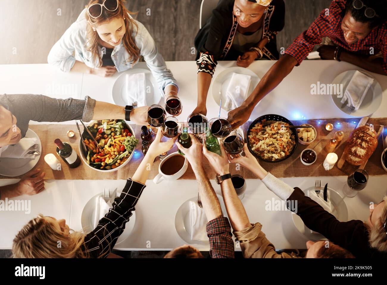 Cheers to friendship and good food. a group of young friends making a ...