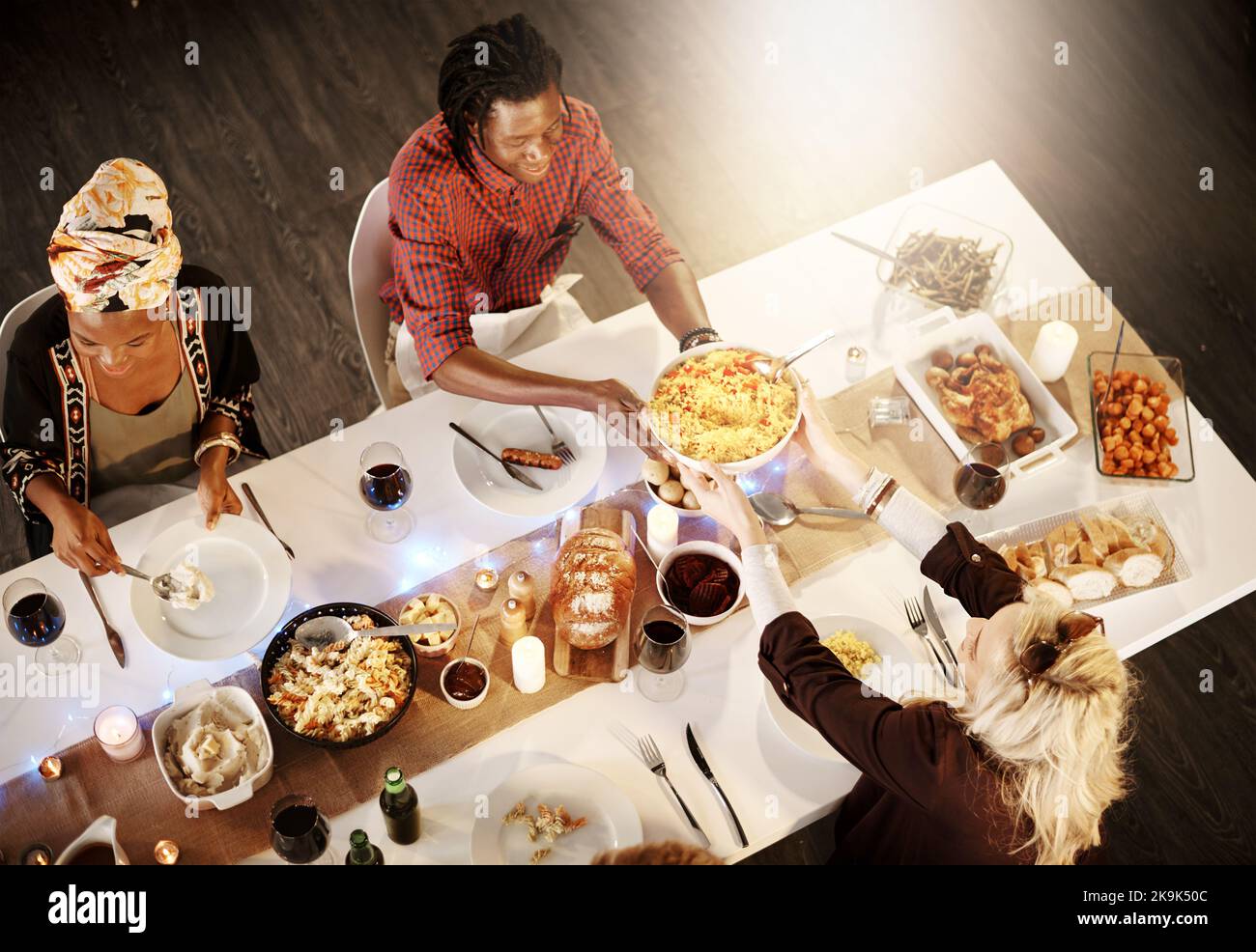 Sharing is caring. High angle shot of friends getting together for a ...