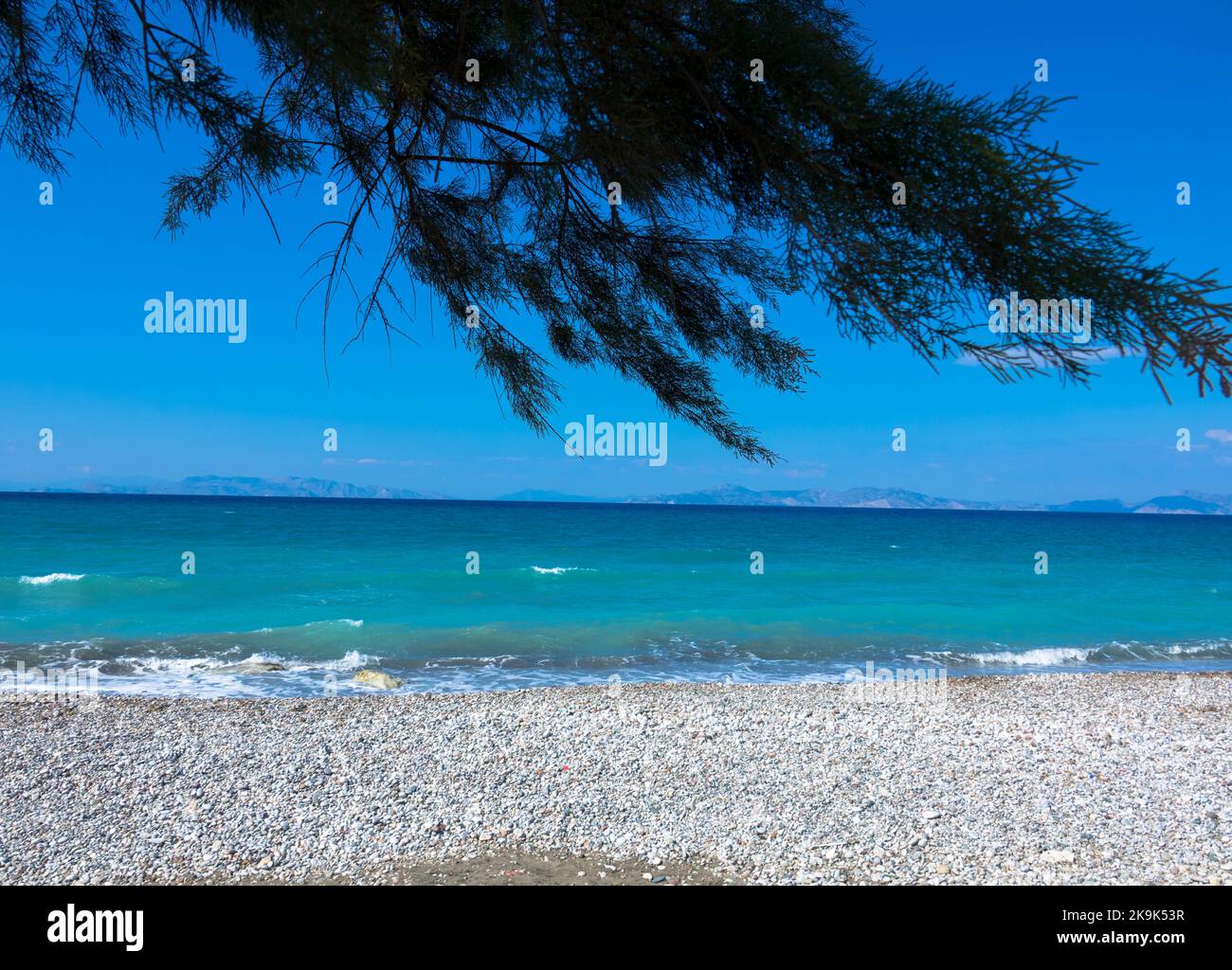 Beautiful and deserted beach on the west coast of Rhodes with tree ...