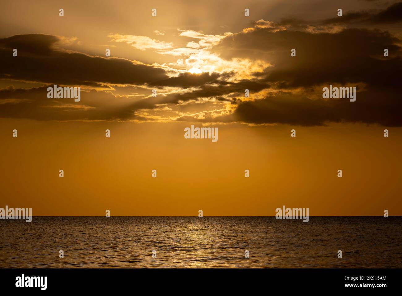 Dramatic red ocean waves at sunset with soft evening sea dark water ...