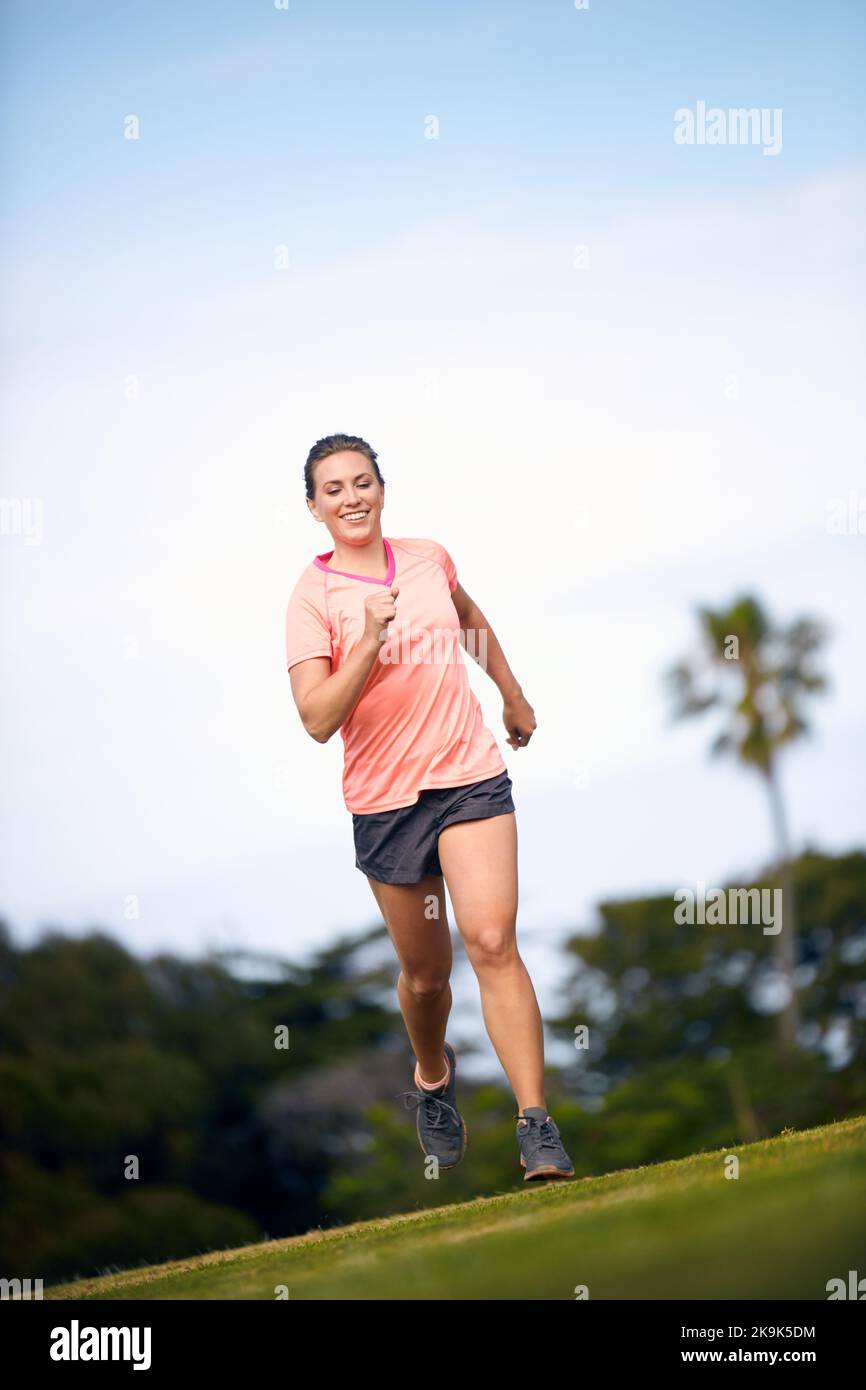Fitness is what you do everyday. a young attractive woman running ...