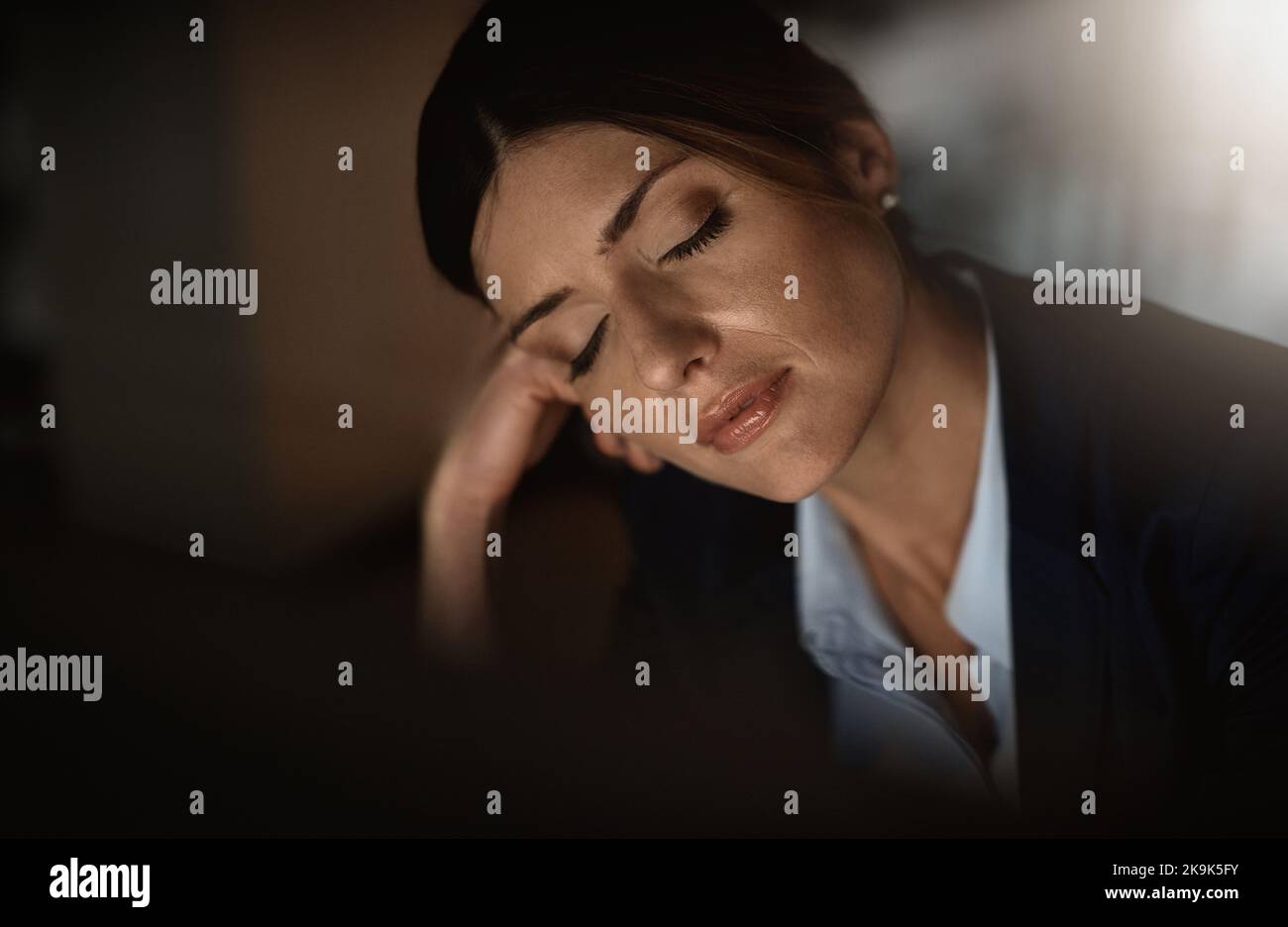 Maybe if I took a power nap at my desk...a young businesswoman falling ...