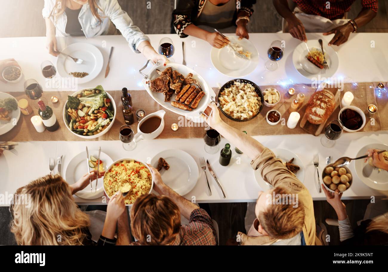 Nothing brings people together like food does. High angle shot of ...