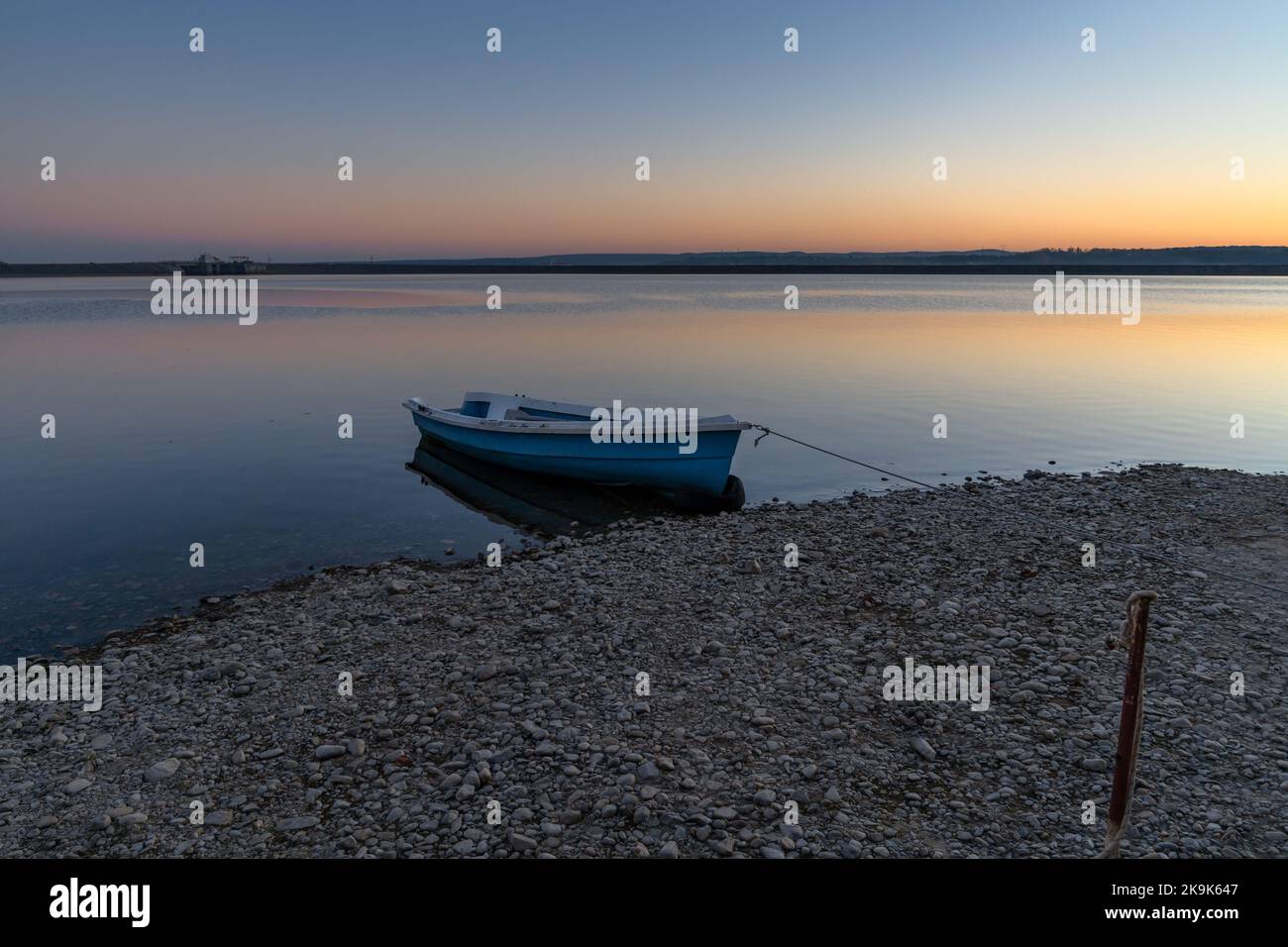Beautiful sunset over Lake Budeasa in central Romania with a wooden ...