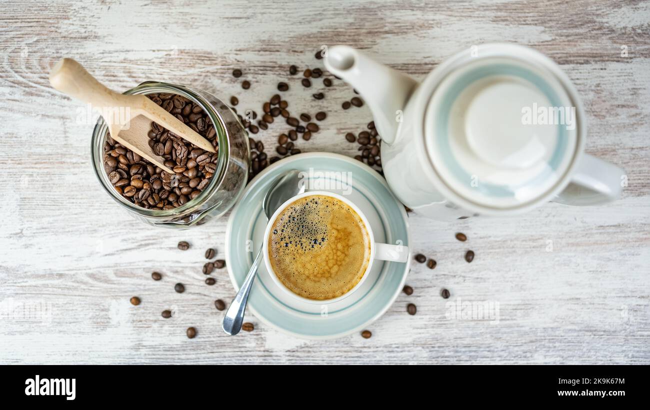 Coffee set with cup of freshly brewed coffee, porcelain coffee maker ...
