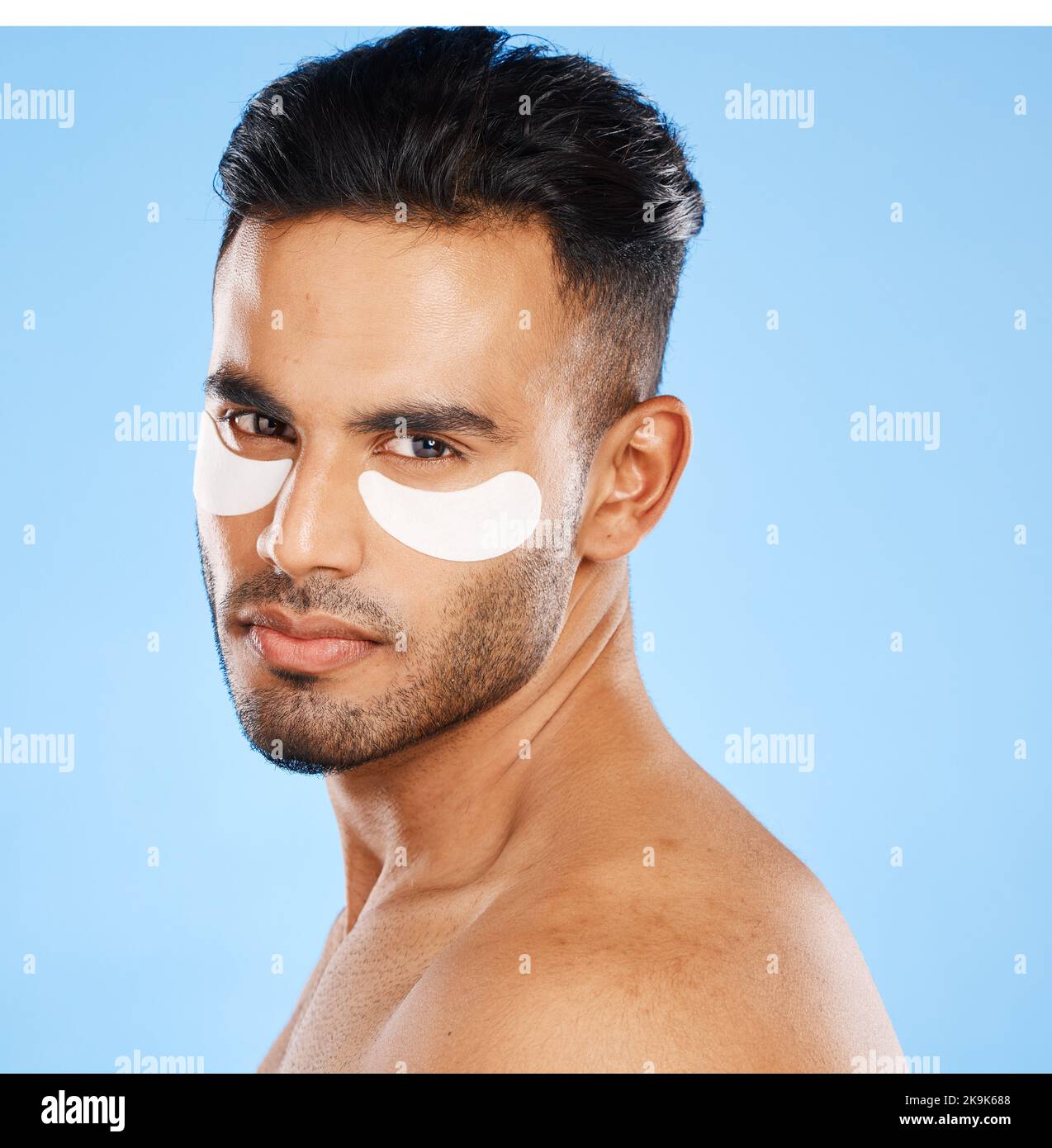 Eye patches, skincare and portrait of man standing in studio doing a ...