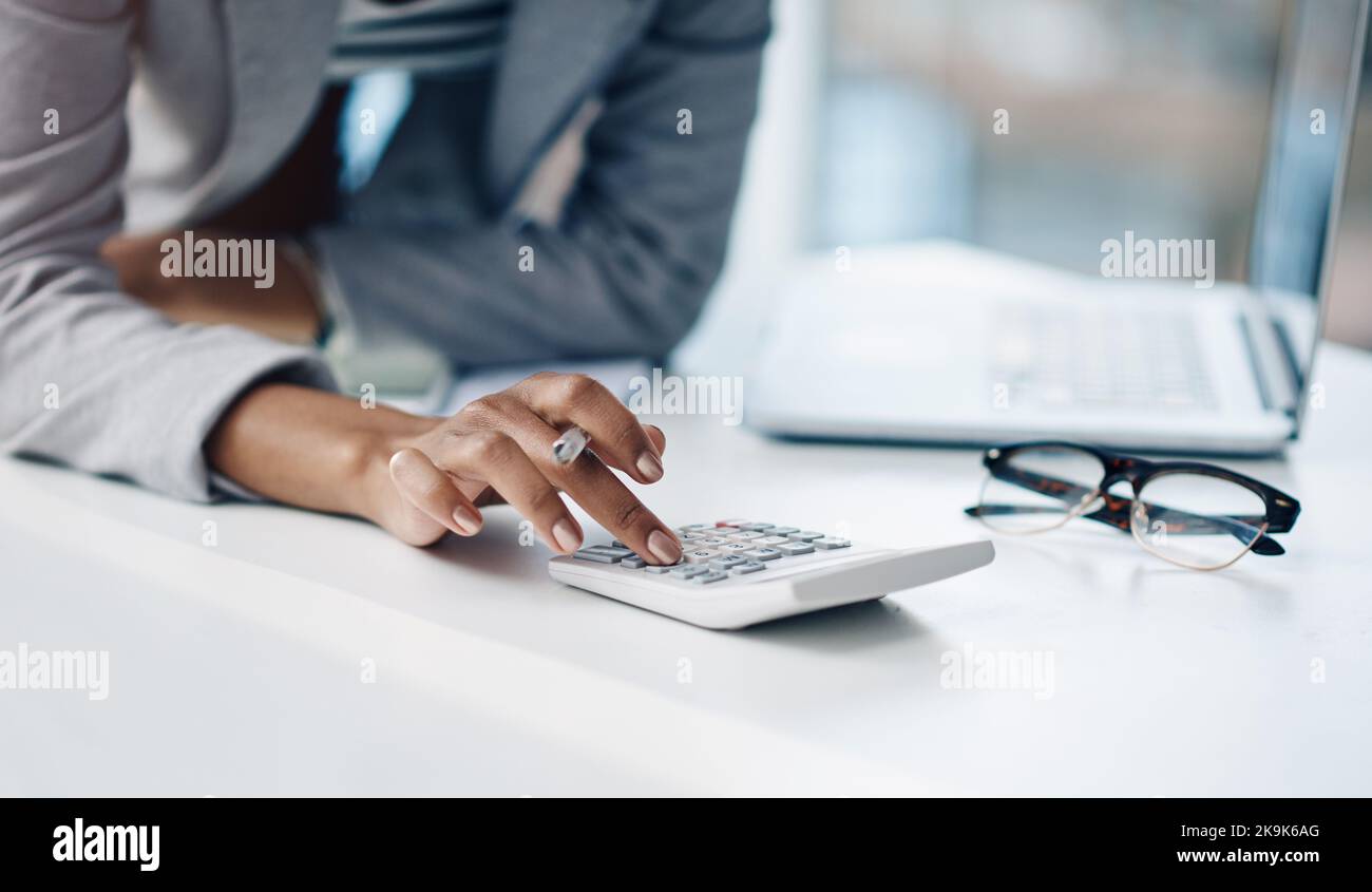 Keeping tabs on business finance. a businesswoman using a calculator at ...