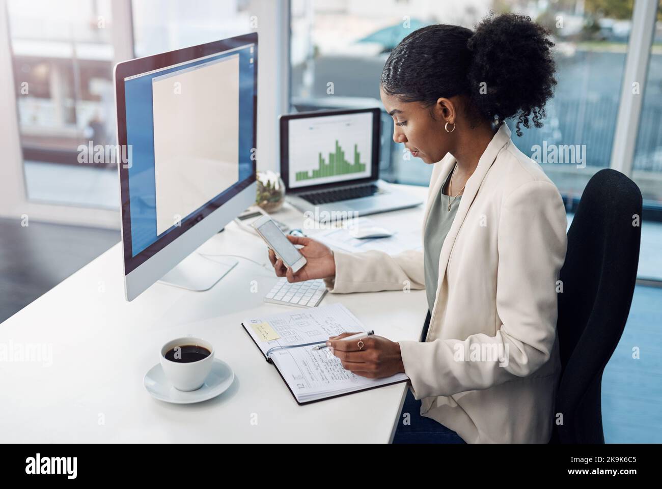 Business numbers are her niche. a young businesswoman using a mobile ...