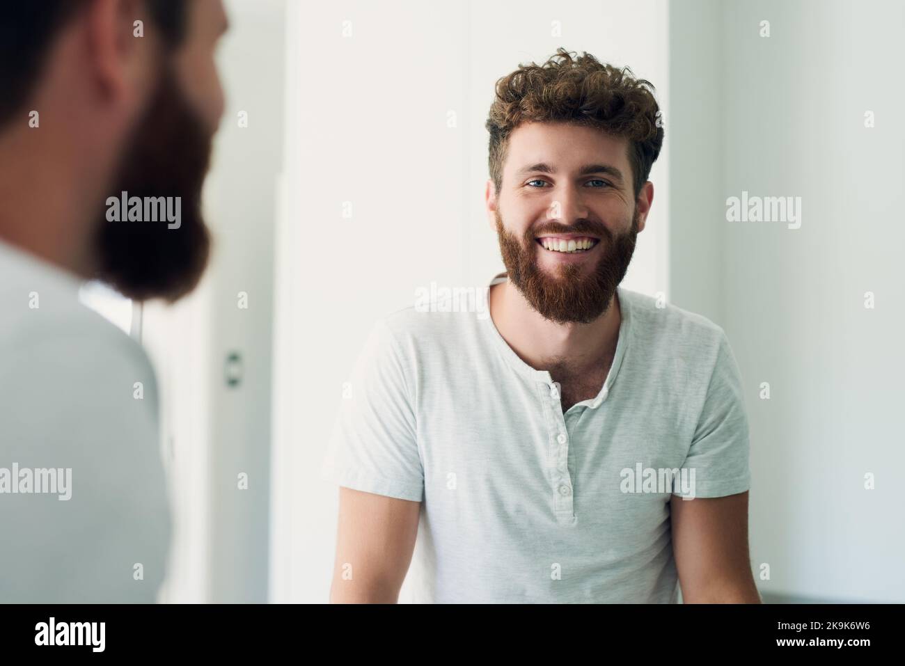 Im fresh and feeling good. a handsome young man looking in the bathroom ...
