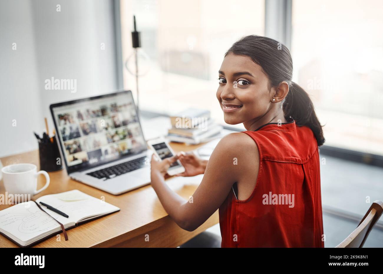 Young woman multiple devices office hi-res stock photography and images ...