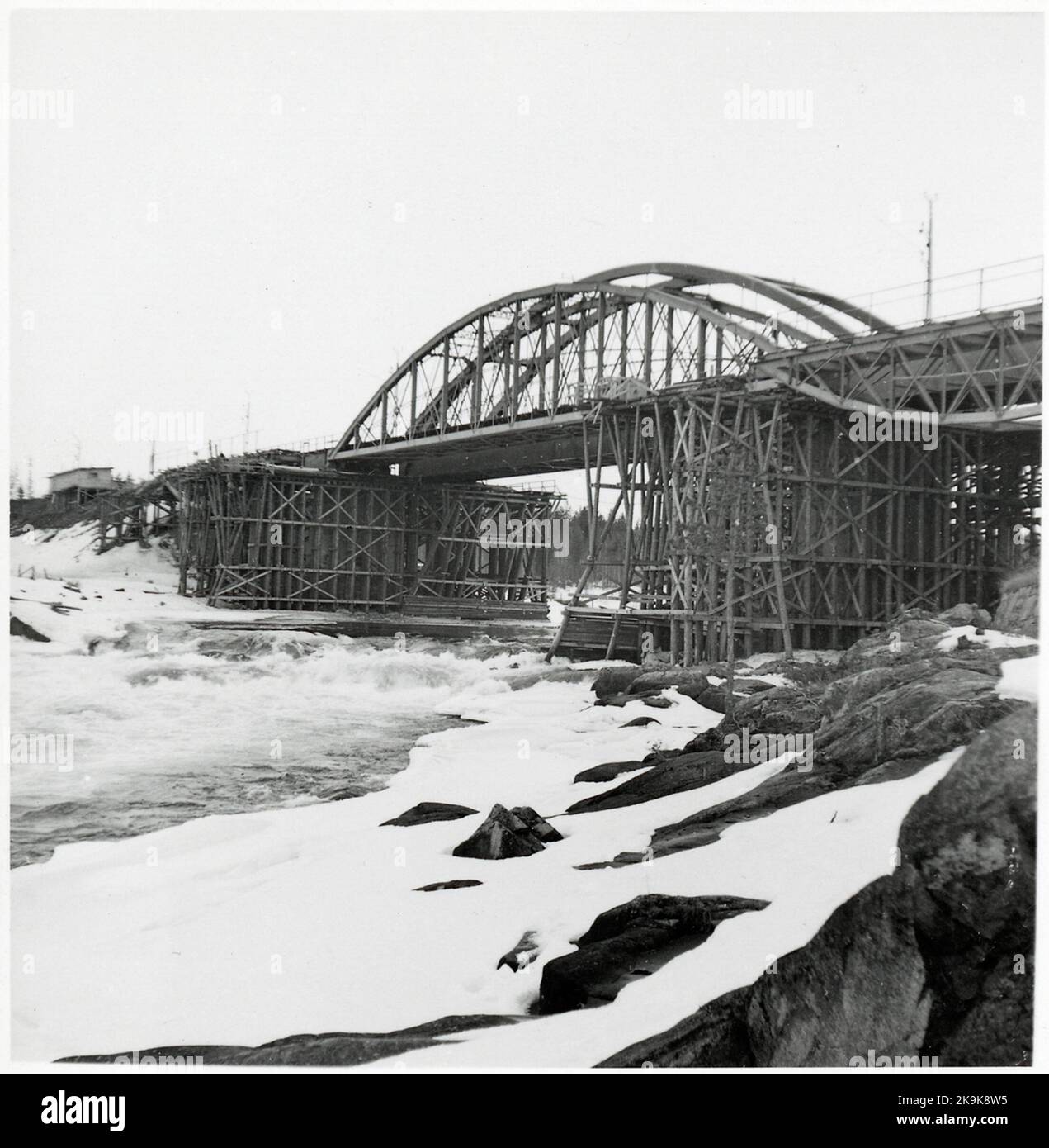 A new bridge is being built across the Skellefte River next to the old ...