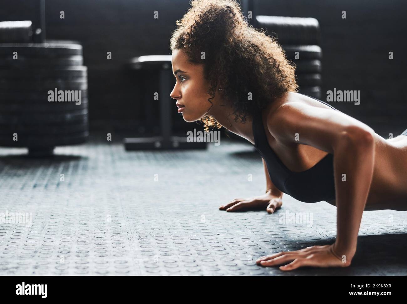 Stay determined and do whats best for you. a young woman doing pushups ...