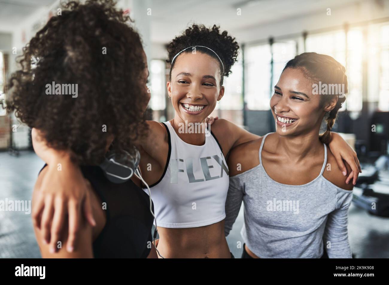 Friends make getting fit even more fun. a group of happy young women ...