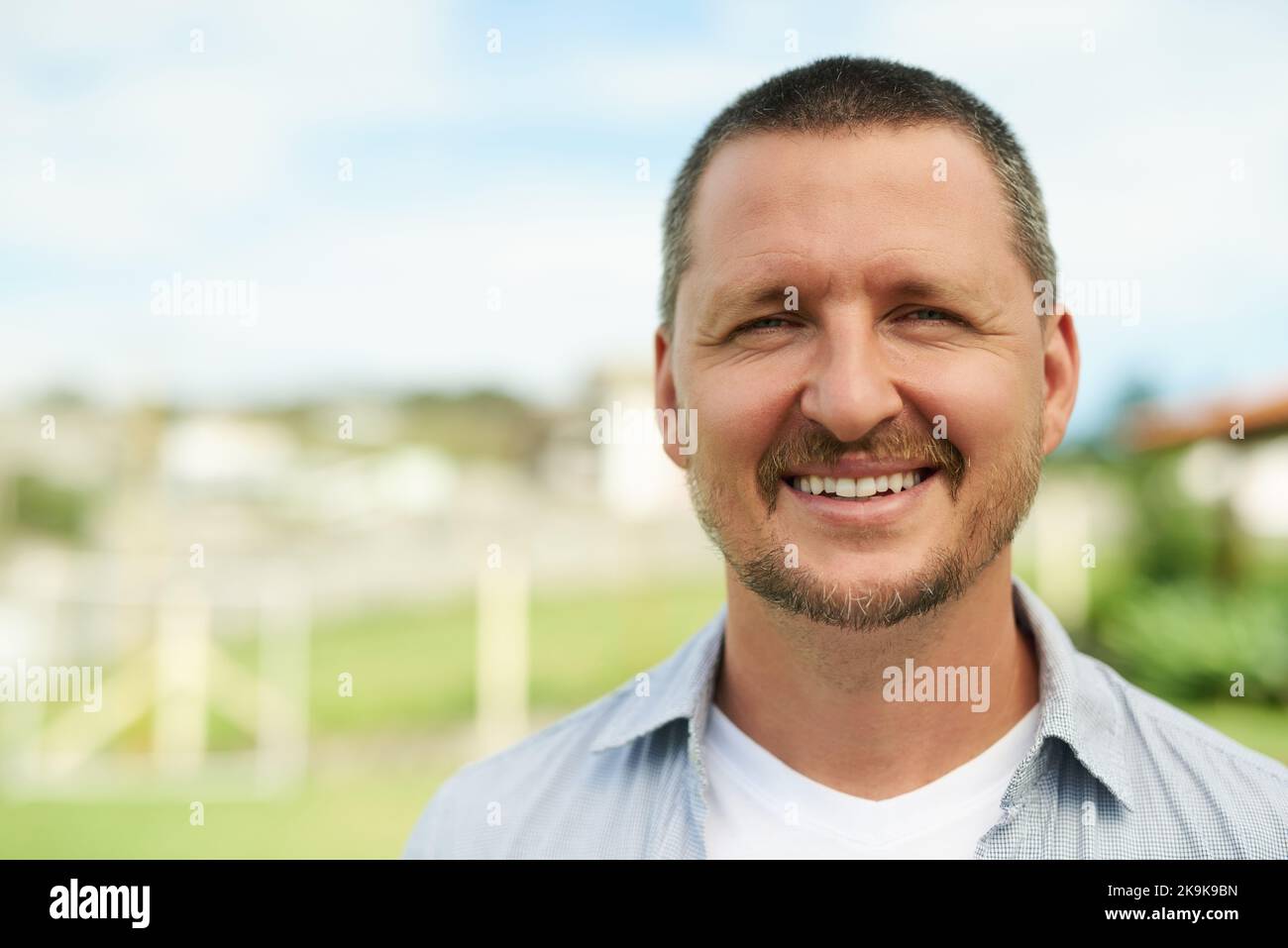 Feeling happy. Cropped portrait of a handsome man in the backyard at ...