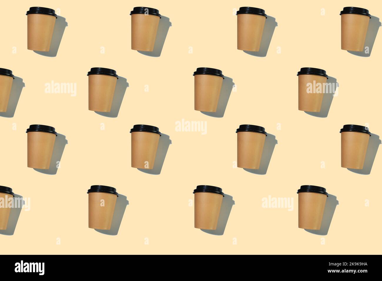 Pattern of cardboard coffee cups with a plastic lid with a hard shadow ...