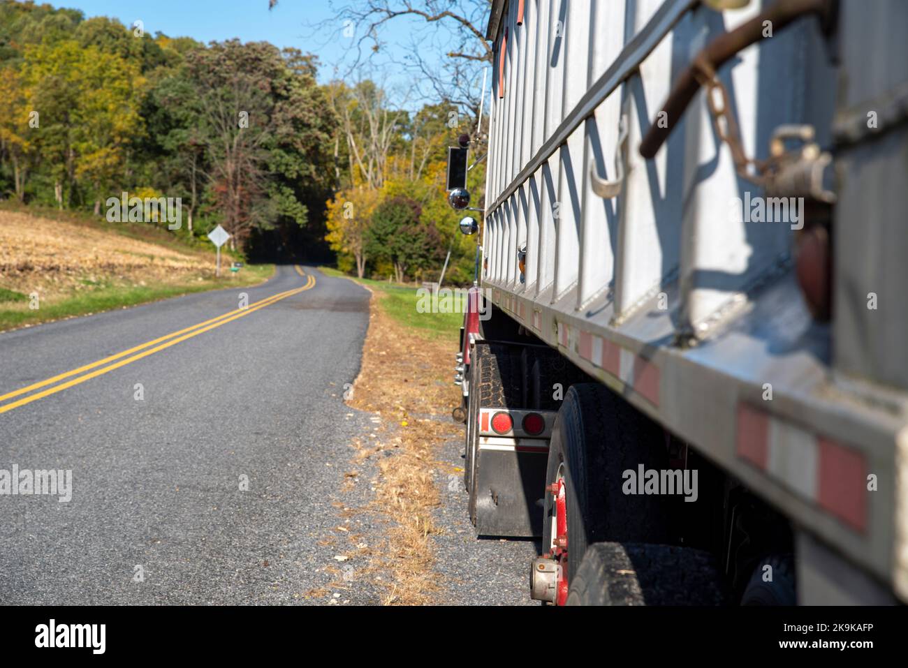 Farm truck closeup side view parked on a country road with autumn ...