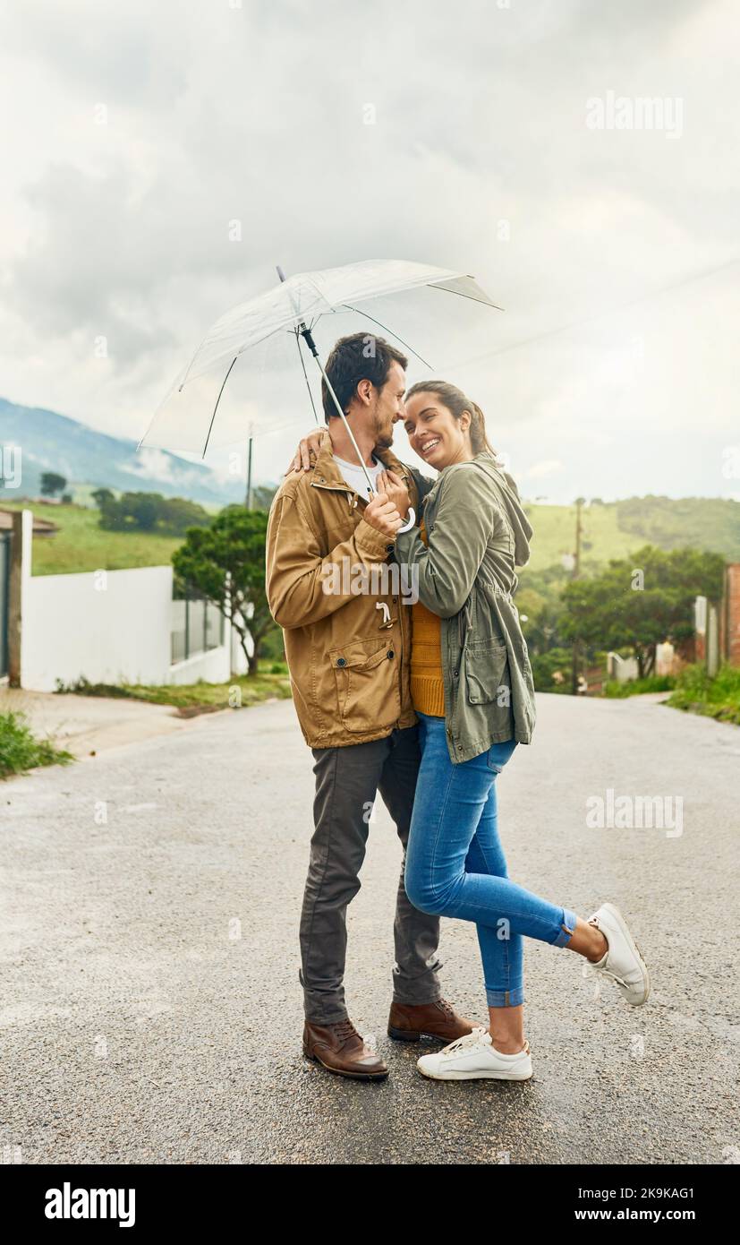 Bad weather is our favorite weather. a loving couple standing outside ...