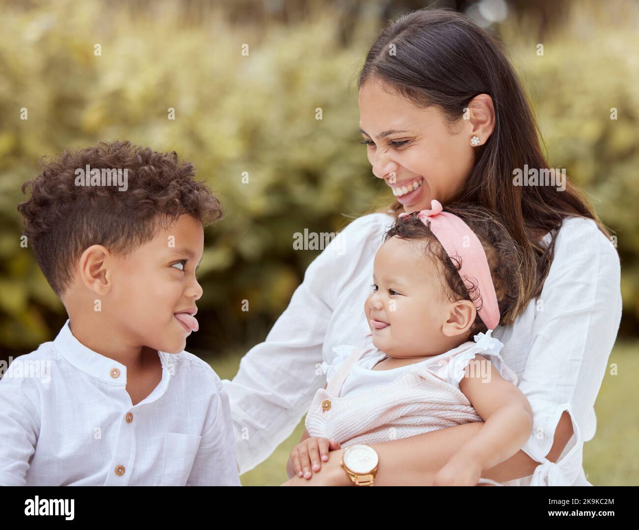 Family, happy and children with a mother having fun with tongue out ...