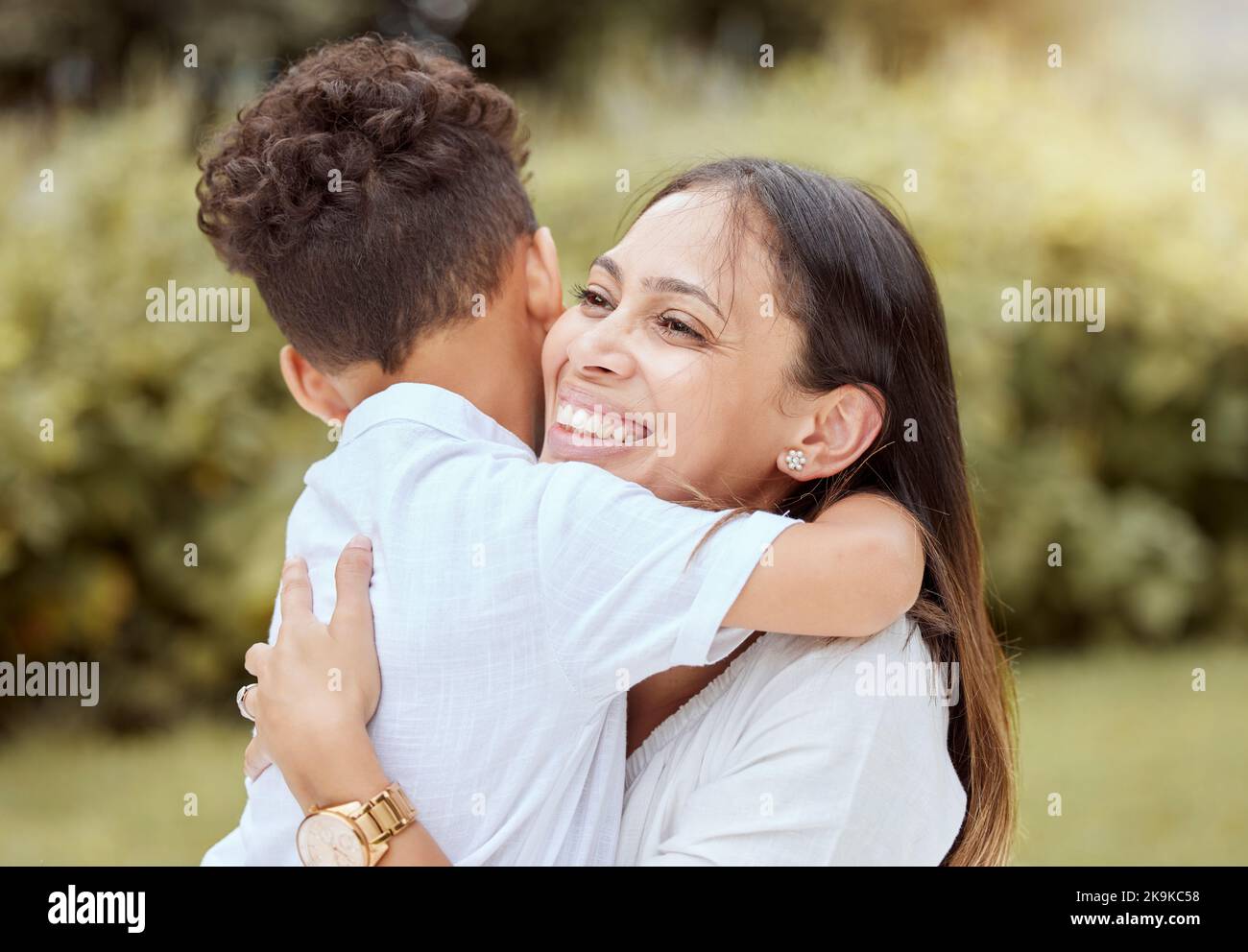 Love, nature and mother hugging child in park or garden with smile, family together on outdoor ...