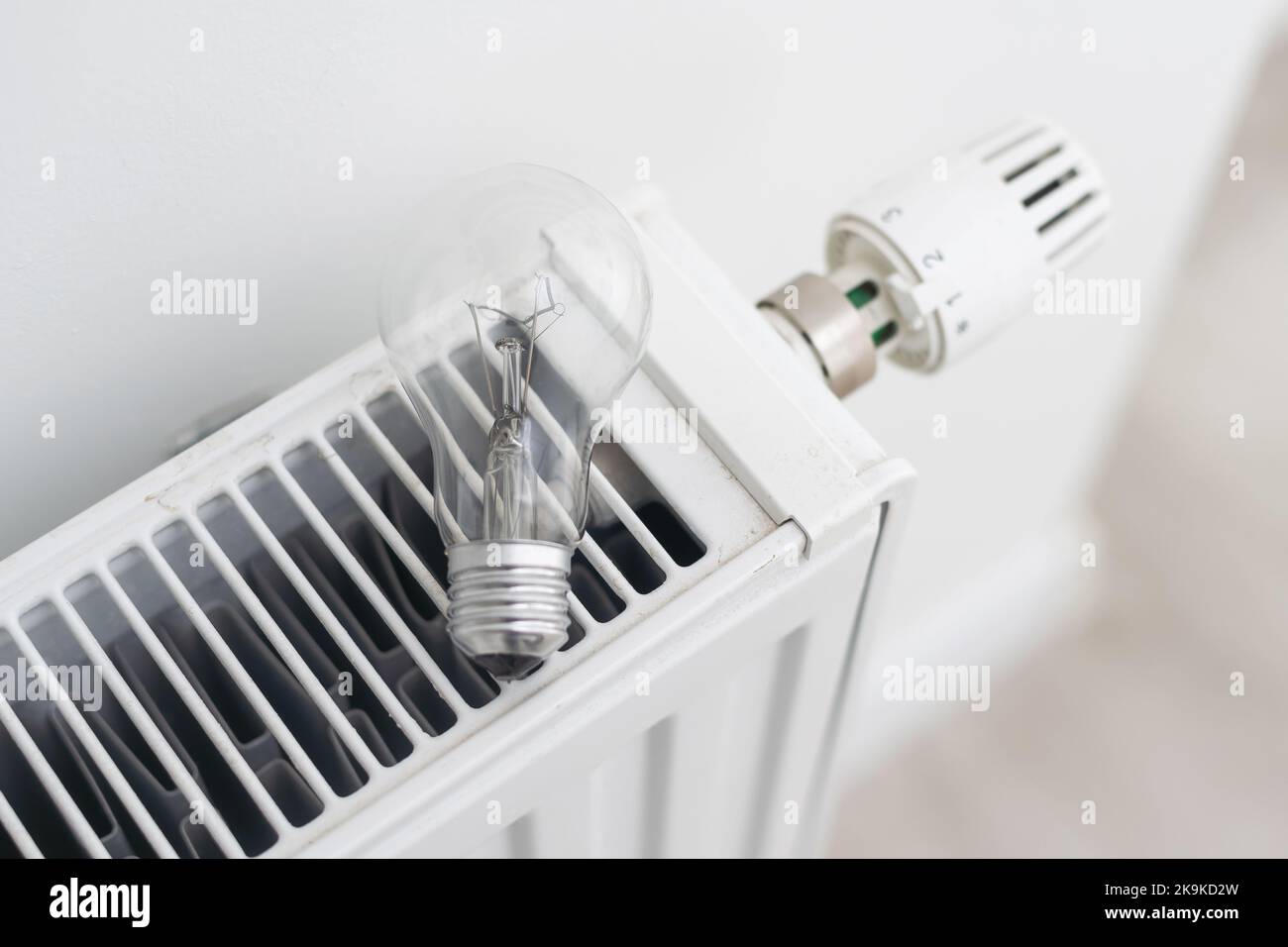 Energy crisis. light bulb on a radiator. electric and gas. Central ...