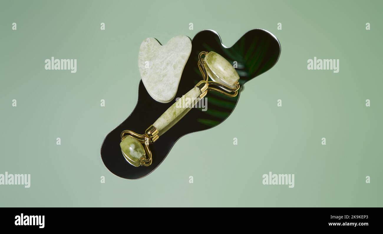 Green jade face roller and Gua Sha scraping for beauty facial massage ...