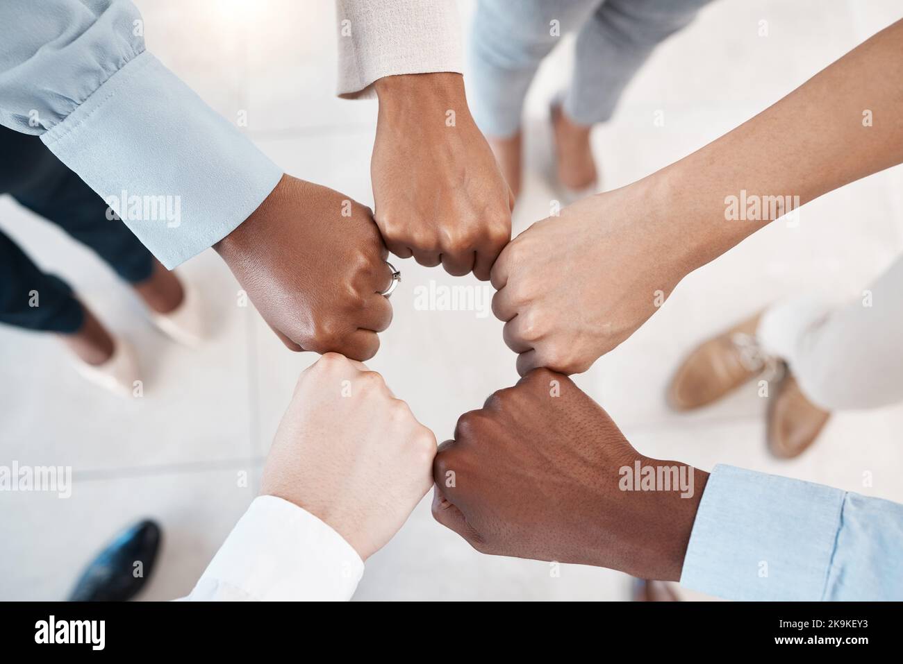 Fist bump, office team and hands together with diversity to show work community, trust and ...