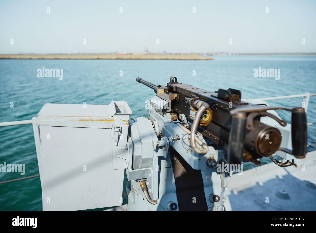 Color image of an automated machine gun on the deck of a military ship ...
