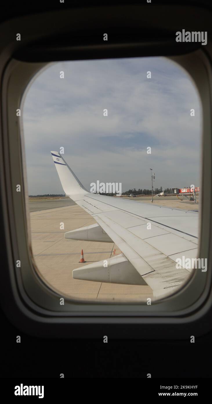 Wing of an airplane, passenger s view. Looking through the window of a ...