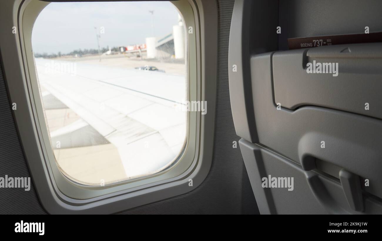 Wing of an airplane, passenger s view. Looking through the window of a ...