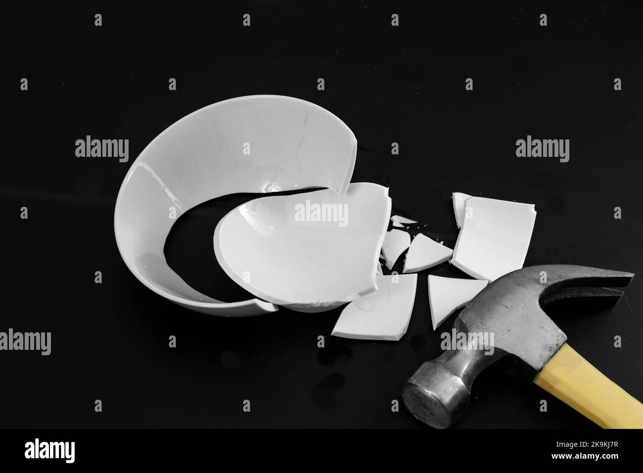 broken to pieces white bowl, isolated on black background, with a ...