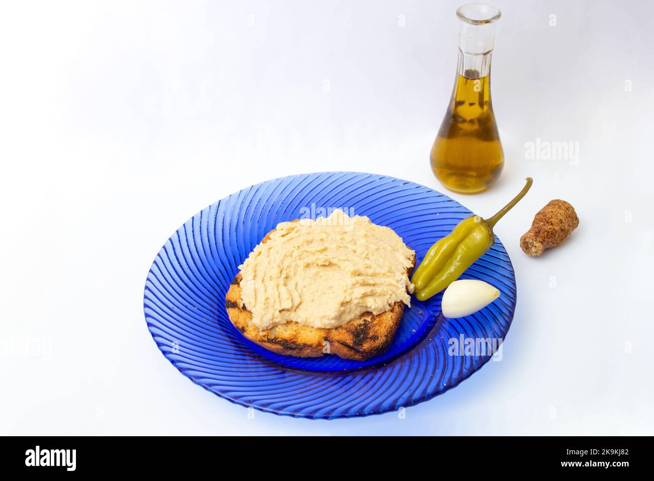 Humus paste with garlic ,pickled green pepper and sesame oil on a ...