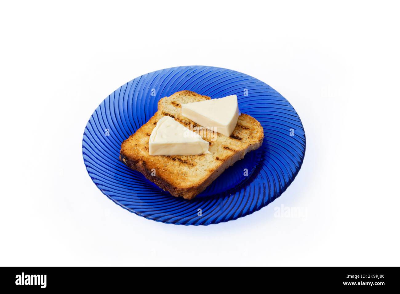 2 cheese triangles on a toasted slice of bread, on a blue glass plate ...