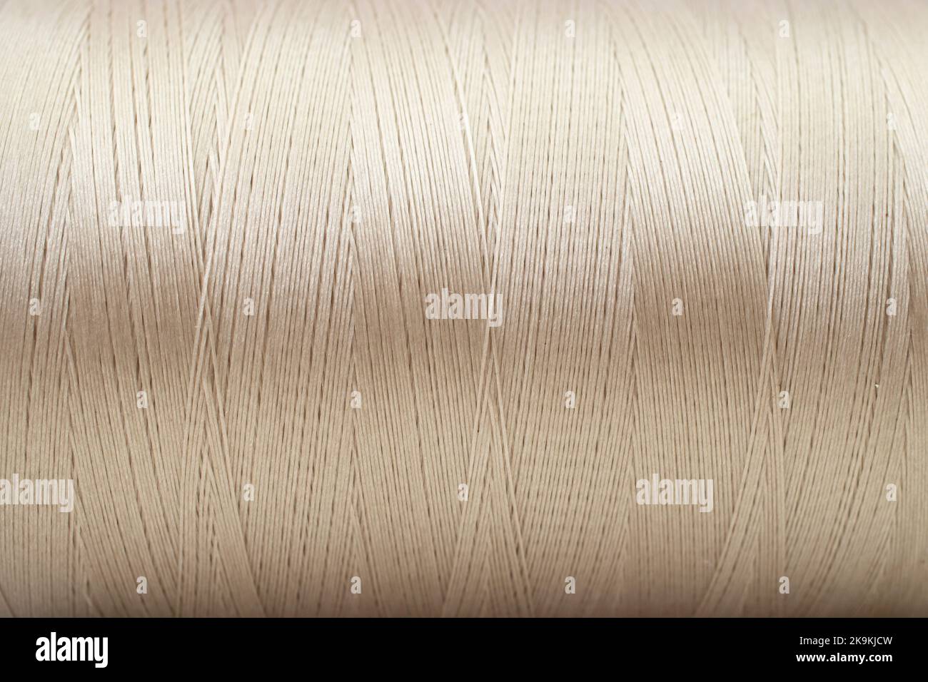 thin thread spool, horizontal full frame backdrop, soft focus close up ...