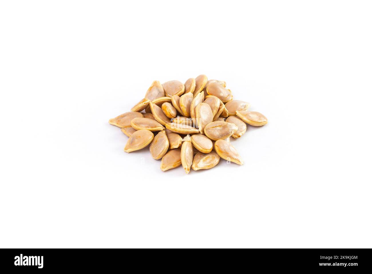 Pumpkin seeds pile isolated on white background, soft focus close up ...