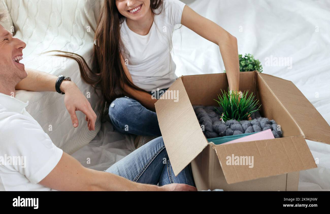 happy couple opening boxes in a new apartment Stock Photo - Alamy