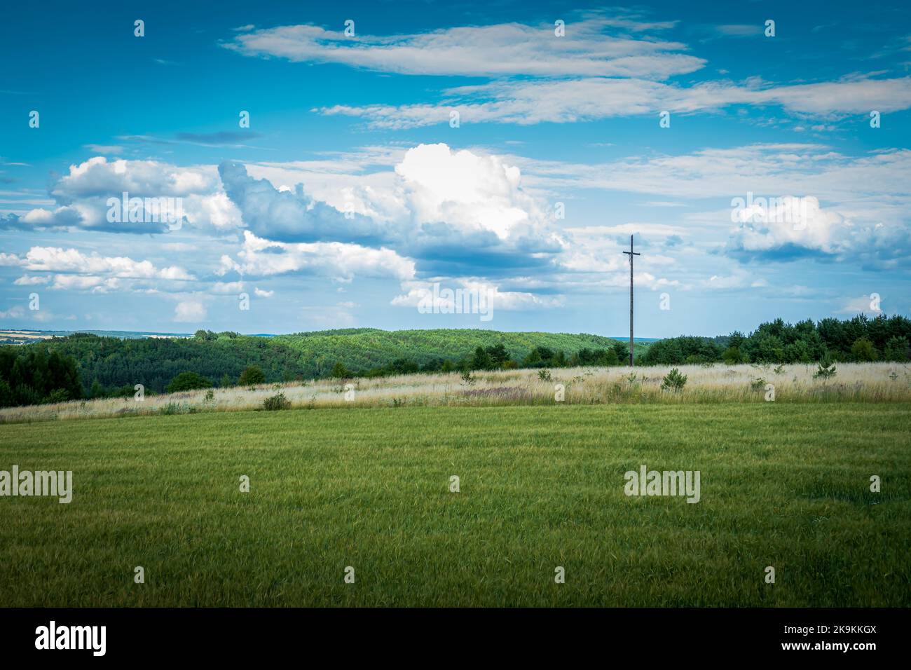 Cross on the hill. Forests, meadows and fields. A beautiful landscape ...