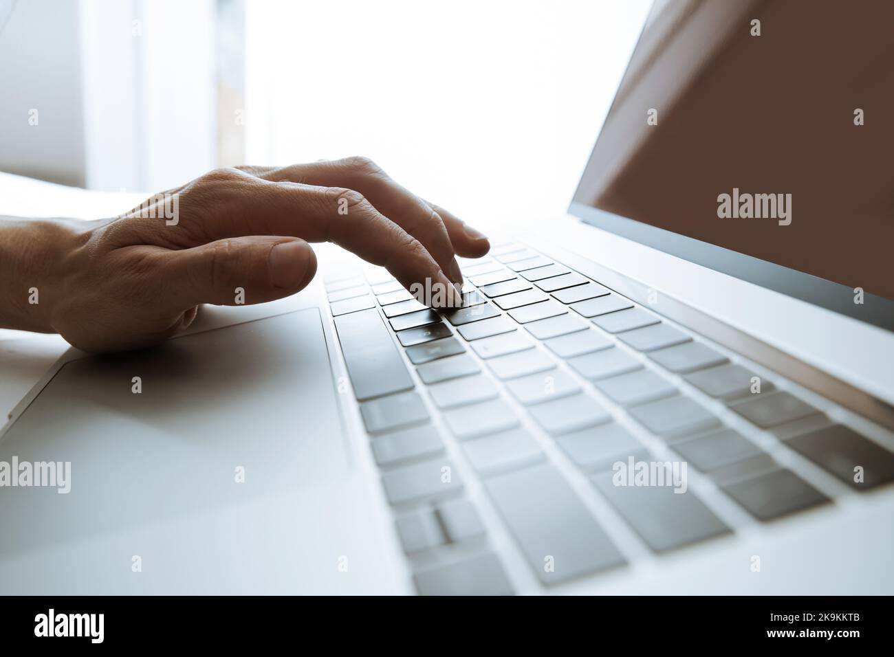 close up. man works by pressing the key of his laptop Stock Photo - Alamy
