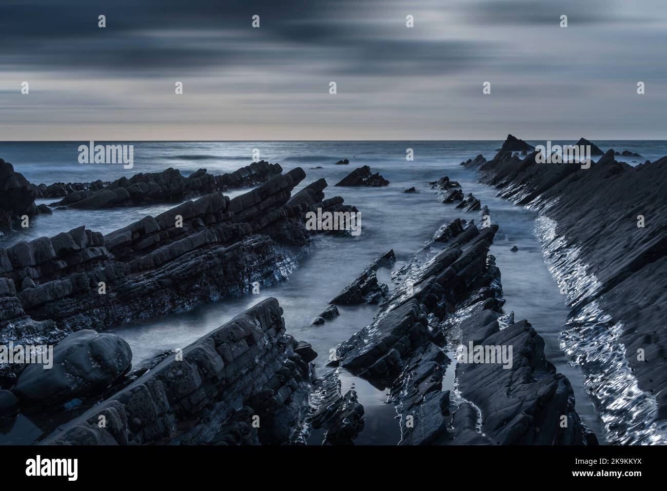 Stunning sunset landscape image of Welcome Mouth Beach in Devon England ...