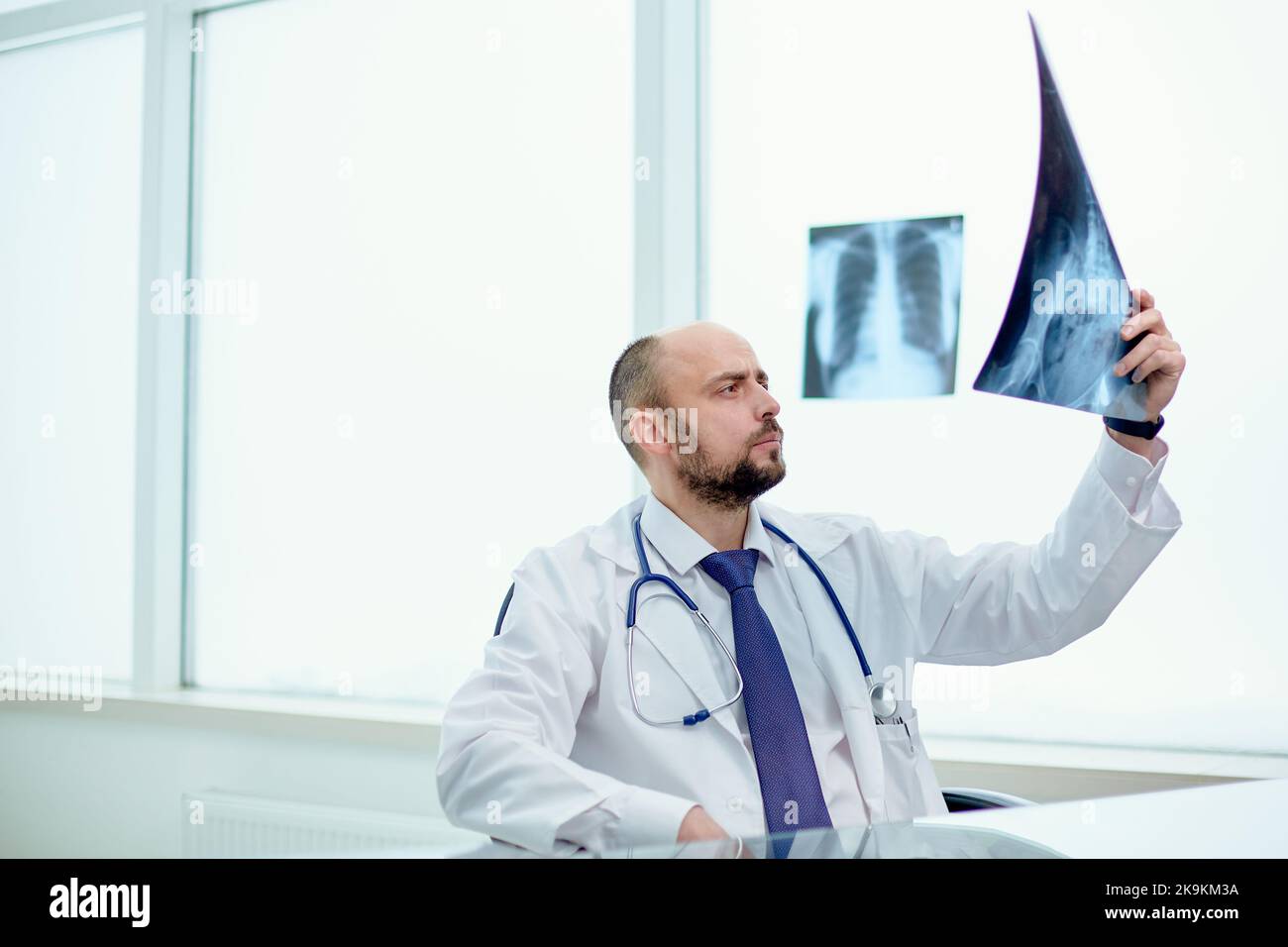 doctor is carefully looking at the X-ray Stock Photo - Alamy