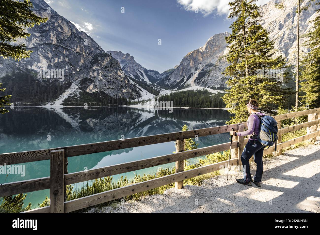 Description: Young woman enjoys amazing view on Braies Lake in ...