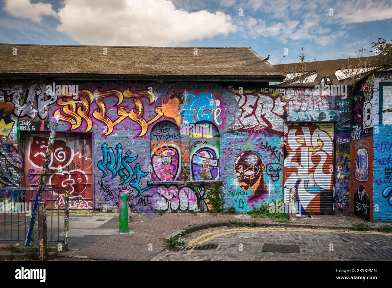 London, UK, July 2022, view of an alley off Brick lane street covered ...