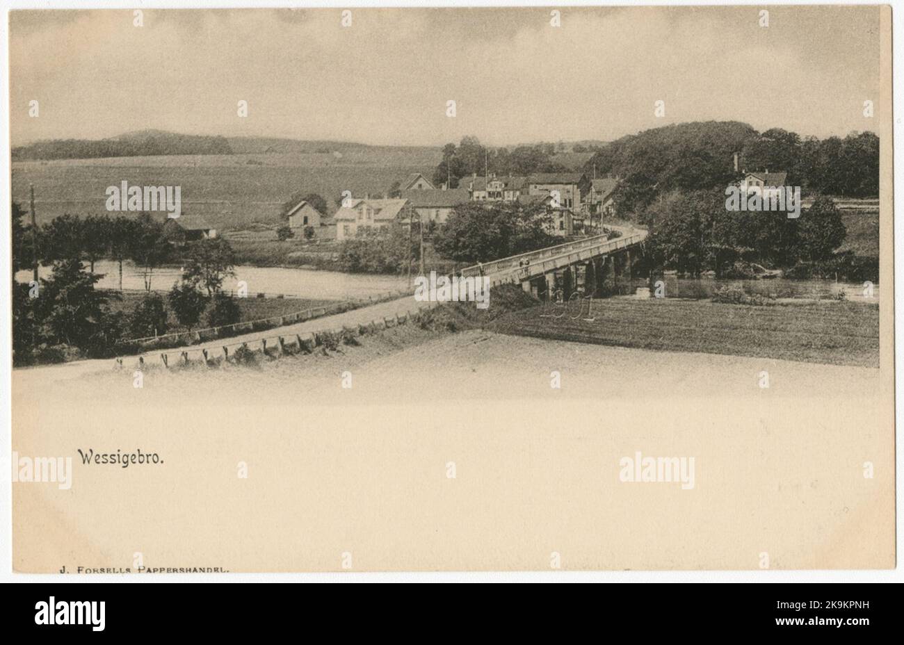The bridge over Ätran with fields and some houses Stock Photo - Alamy