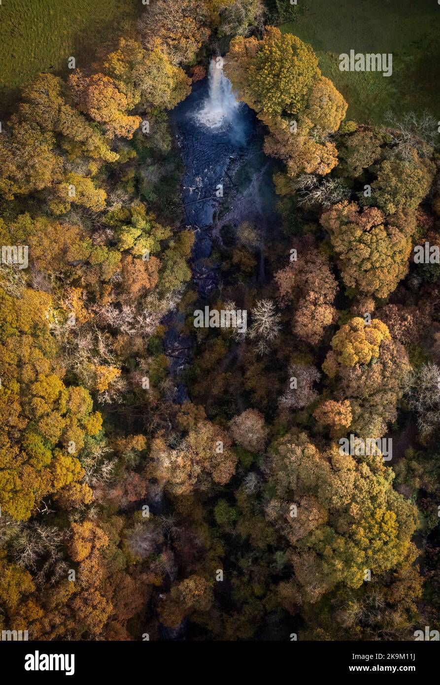 Aerial view of water flowing over Henrhyd Falls, the highest waterfall ...