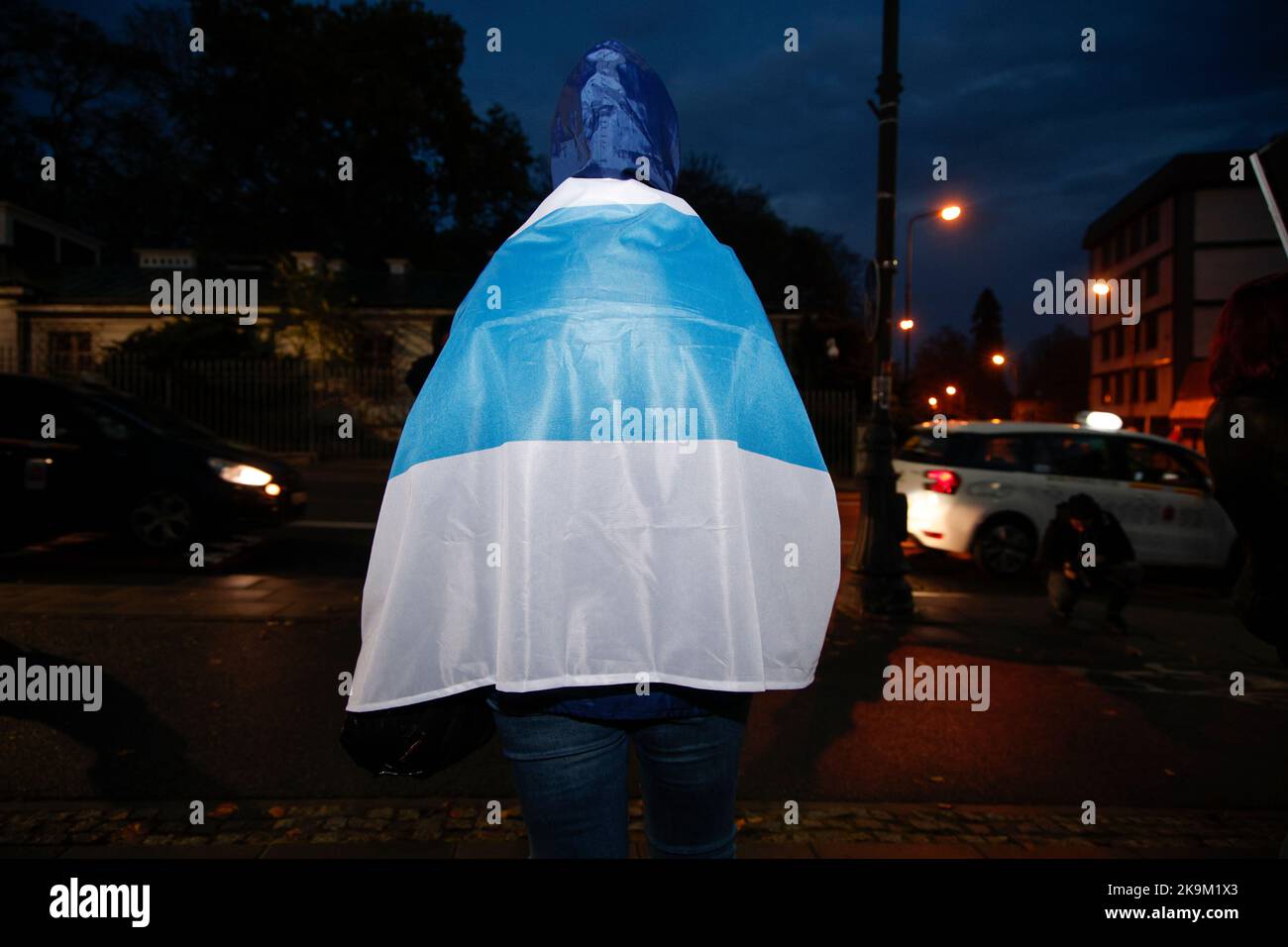 A woman wearing the white-blue-white Russian flag, a sumbol against the ...