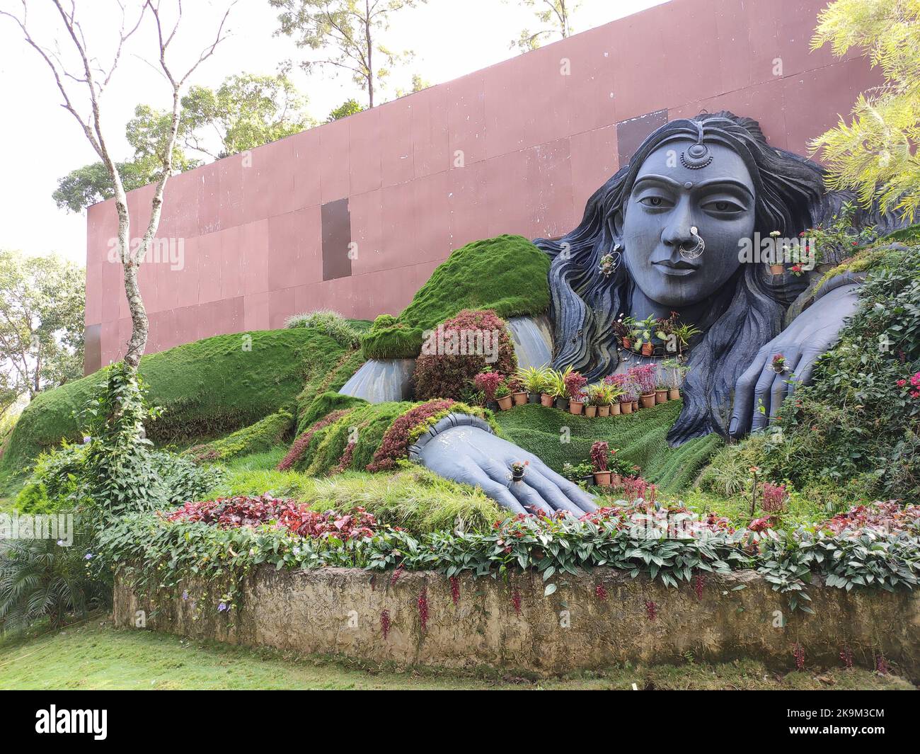 Lady statue whose decorations are made of flower pots. Sculpture of a ...