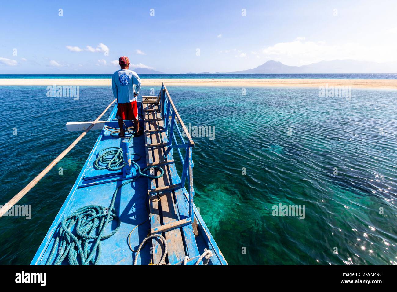 A Filipino man looking out of a tradition boat's prow as it gets ready ...