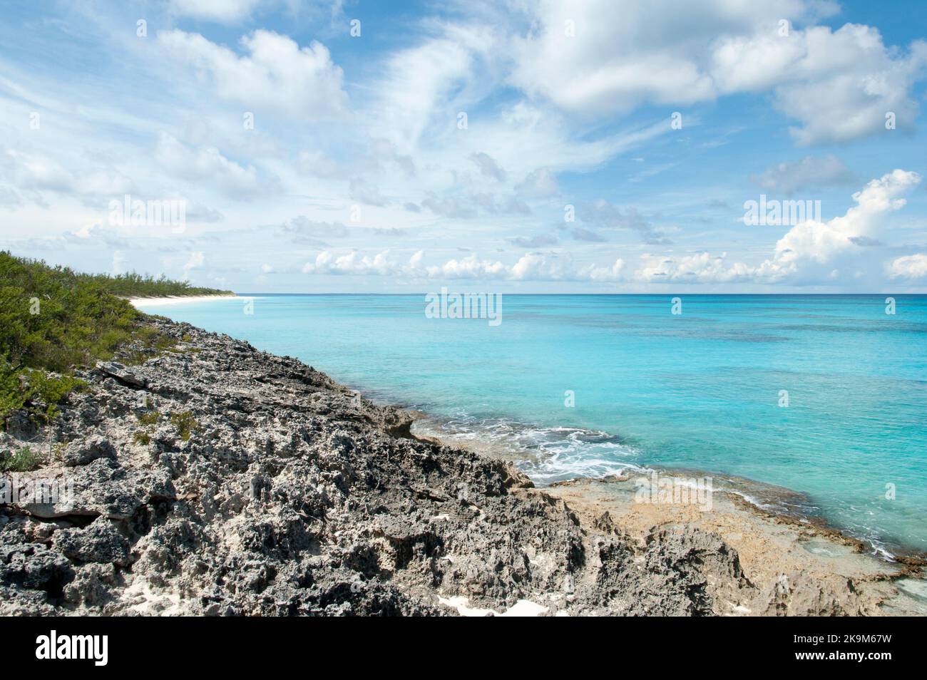The scenic view of a sharp eroded shore and a sandy beach in a ...