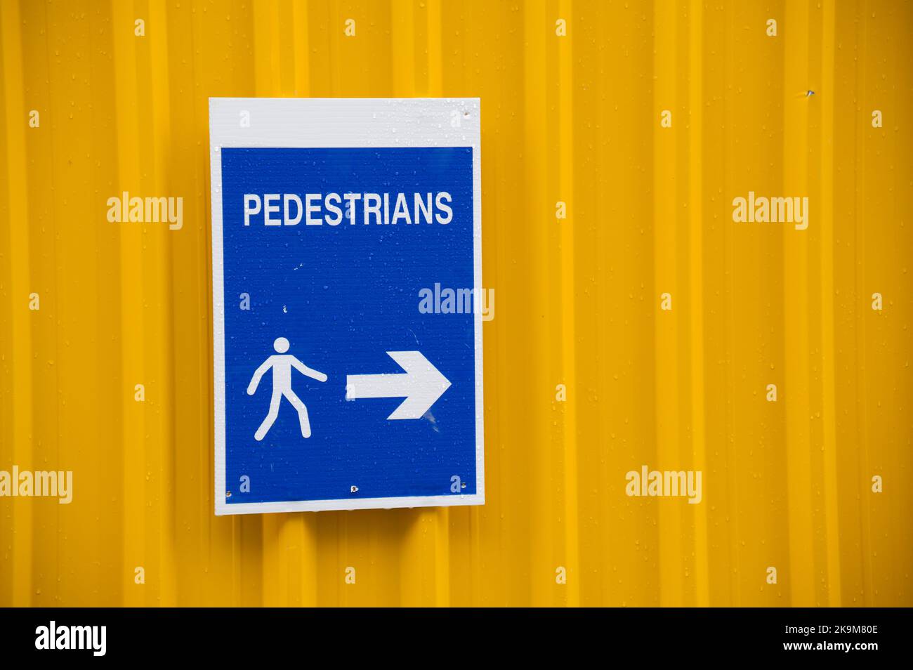 Pedestrian walkway sign at construction building site fence Stock Photo ...