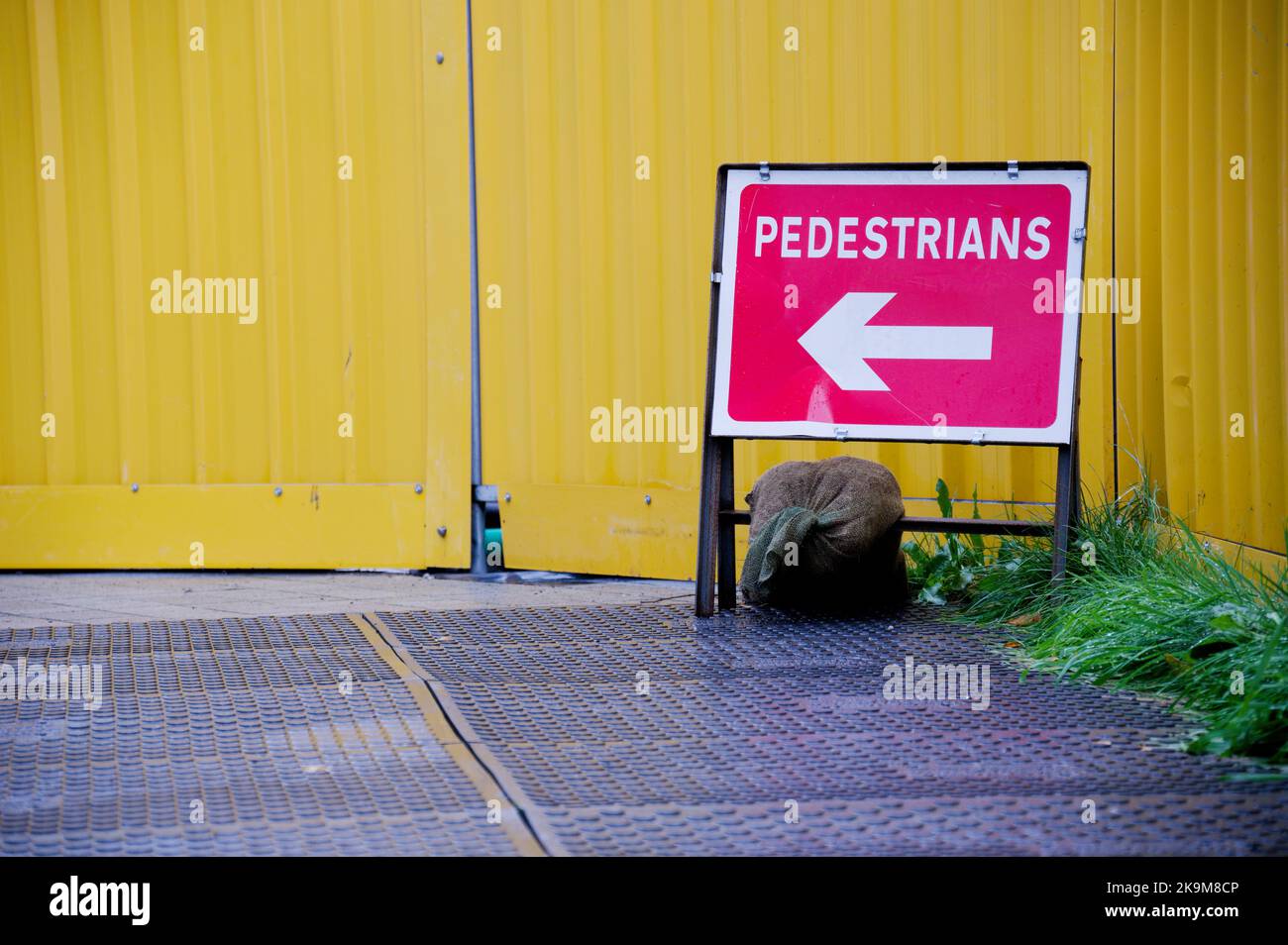 Pedestrian walkway sign at construction building site fence Stock Photo ...