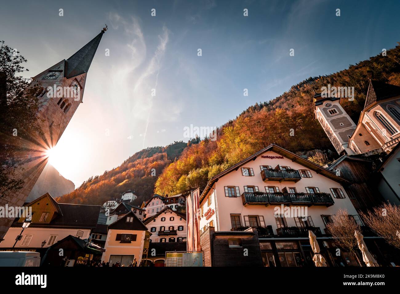 Scenic autumn view of Hallstatt and it's two churches surrounded by ...